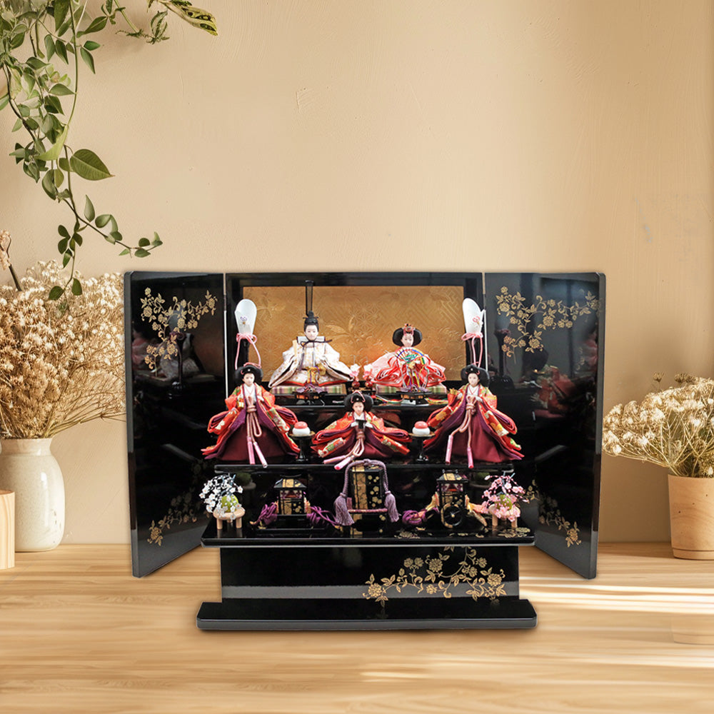 A Hina doll displayed in a compact box. 3-tiered display with 5 dolls ...